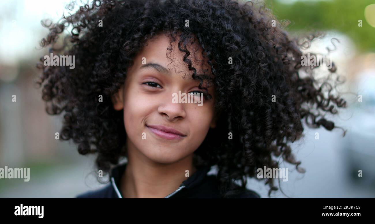 Happy Brazilian child smiling at camera. Hispanic black girl kid with ...