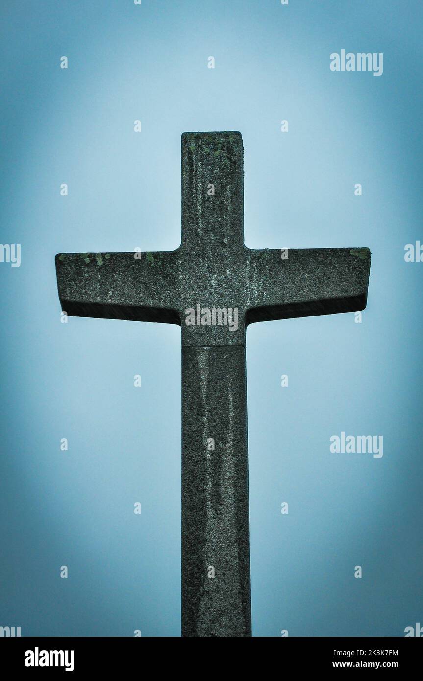 A vertical shot of a catholic cross in Huisnes German Cemetery ...