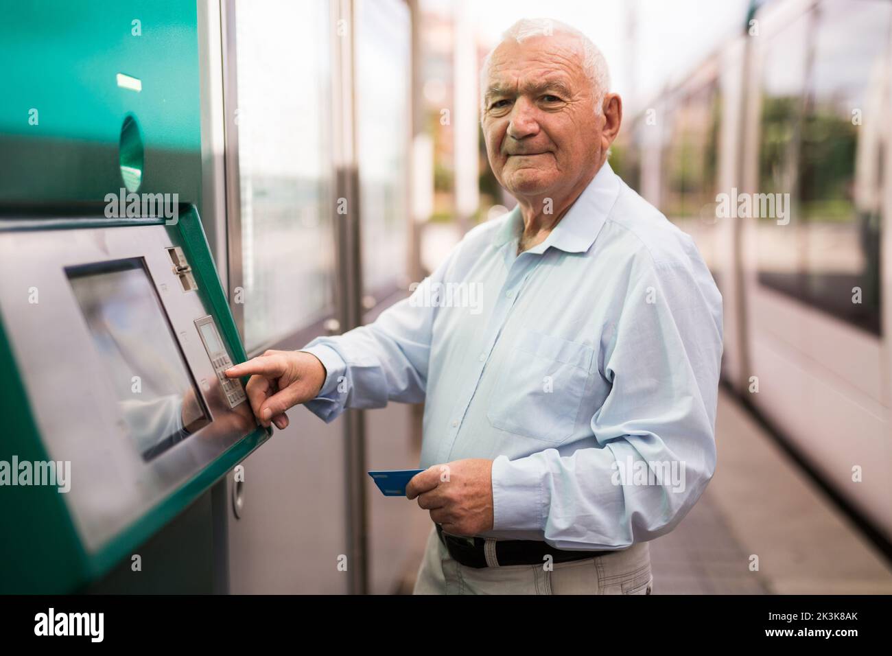 Elderly man using cash machine Stock Photo - Alamy