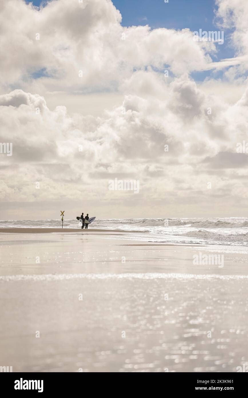 27 September 2022, Schleswig-Holstein, Westerland/Sylt: Two surfers are ...