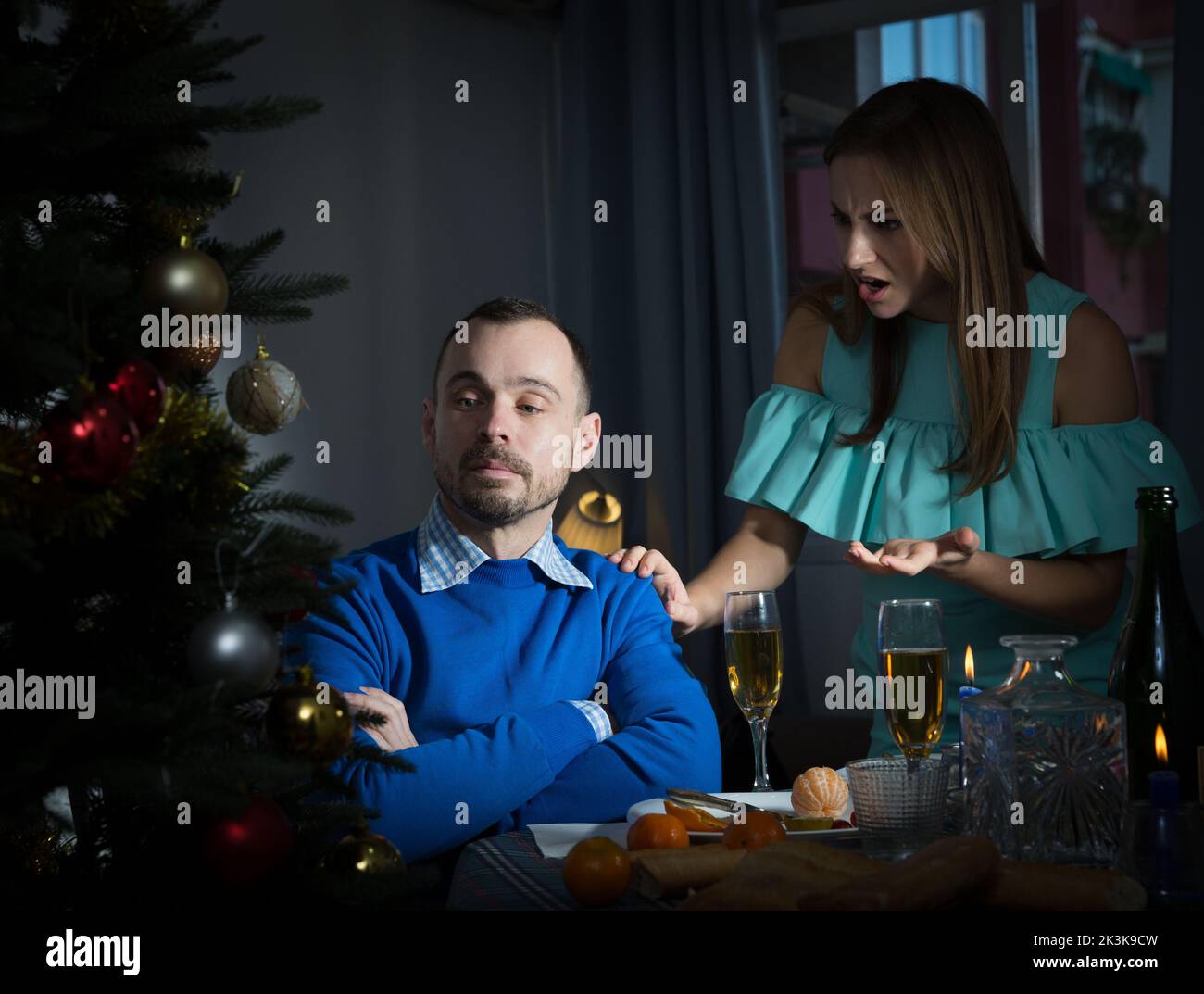 Upset man with screaming wife during celebration of Christmas Stock ...