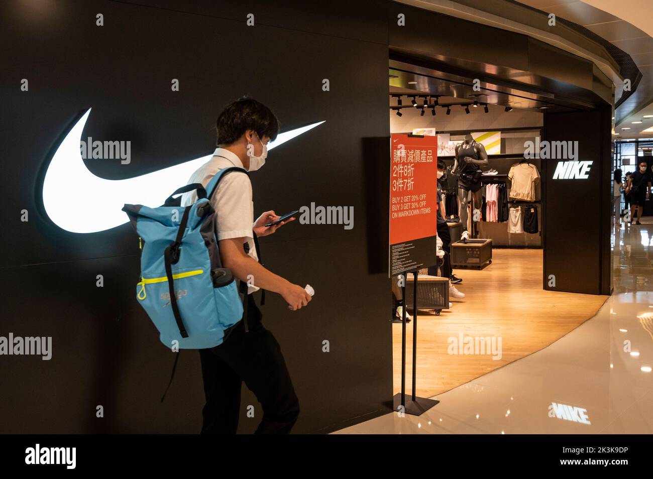 A young shopper walks past the American multinational sports clothing ...