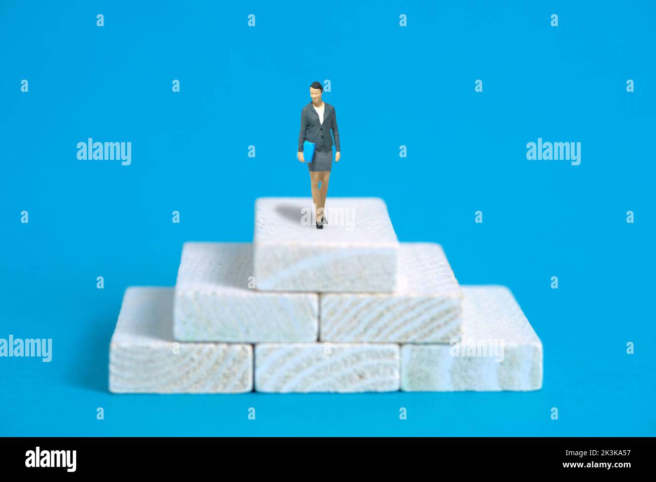 Businessmen standing using binoculars above white stair podium ...