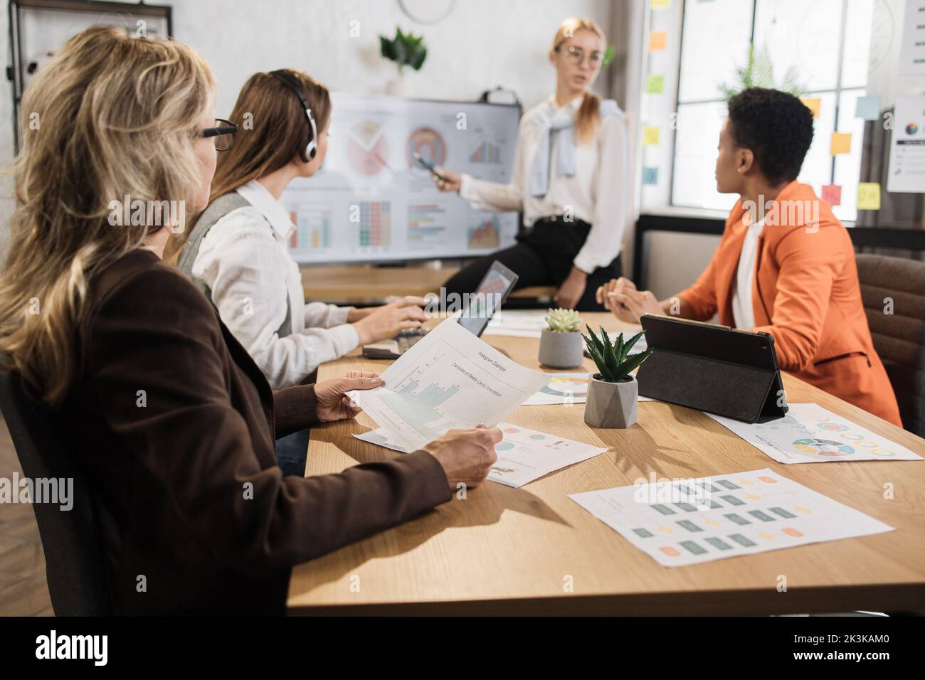 Blur background of multicultural female financiers discussing strategy ...