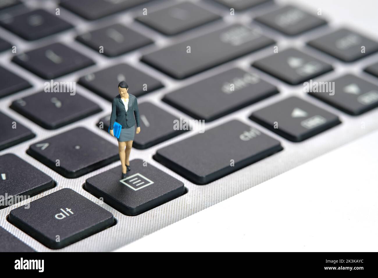 Miniature people toy figure photography. A businesswoman standing above ...