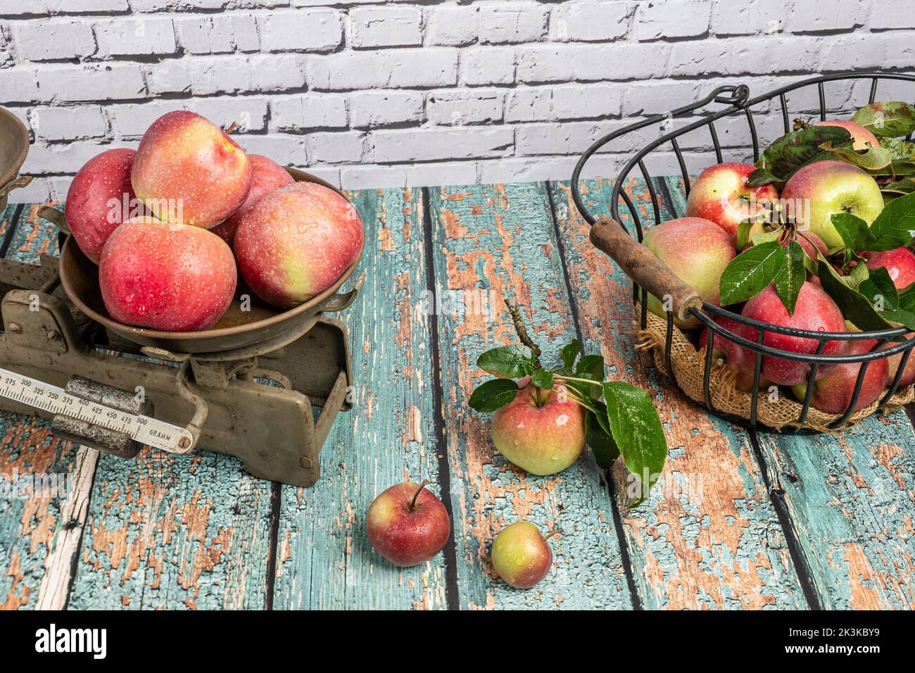 Apples are in a weighing pan of an old scale, others are in a basket ...