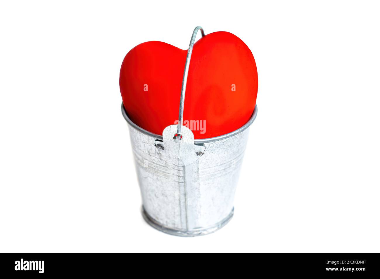 Large red heart placed in a steel water bucket isolated on white ...