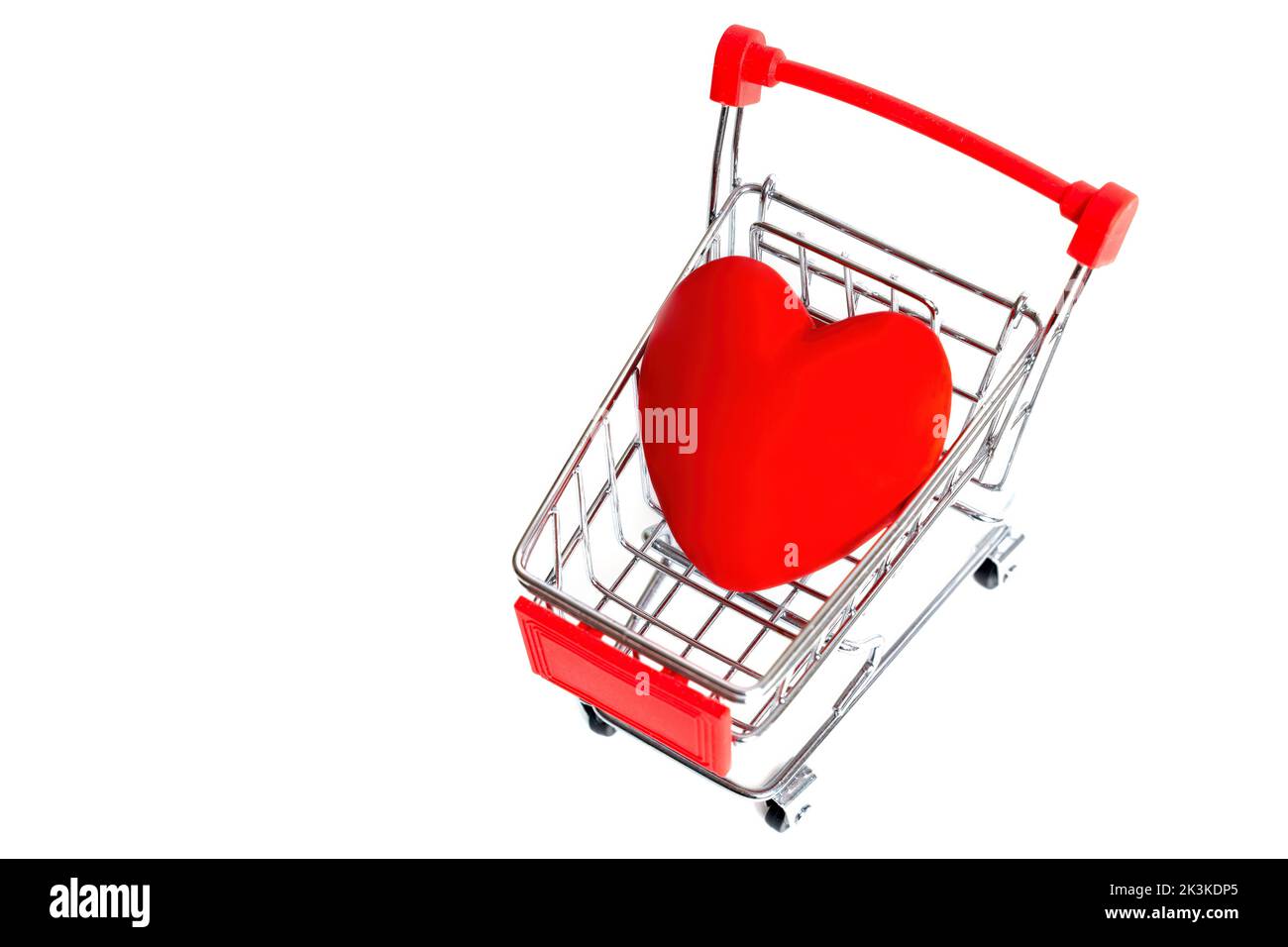 Miniature push cart with a large red heart isolated on white background ...