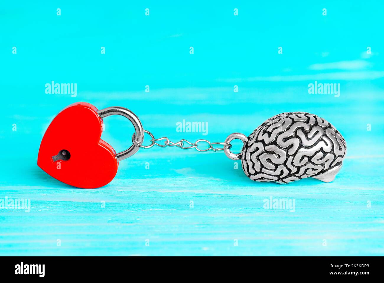 Steel copy of a human brain attached to a red heart-shaped padlock ...