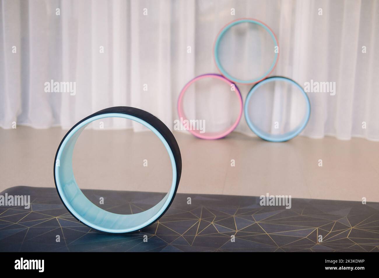 a set of yoga wheels lying on the mat. Fitness Equipment Pilates Ring ...