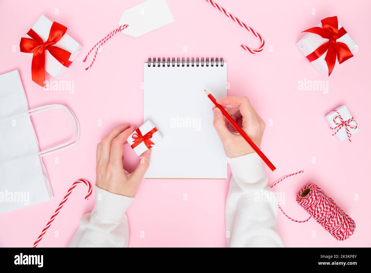 Christmas cozy background. Female hand writing in blank notebook with ...