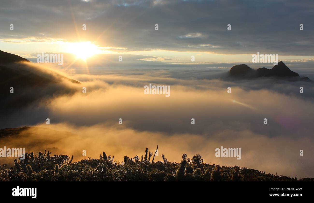 Sunset at the top of the mountain, below a sea of clouds Stock Photo ...