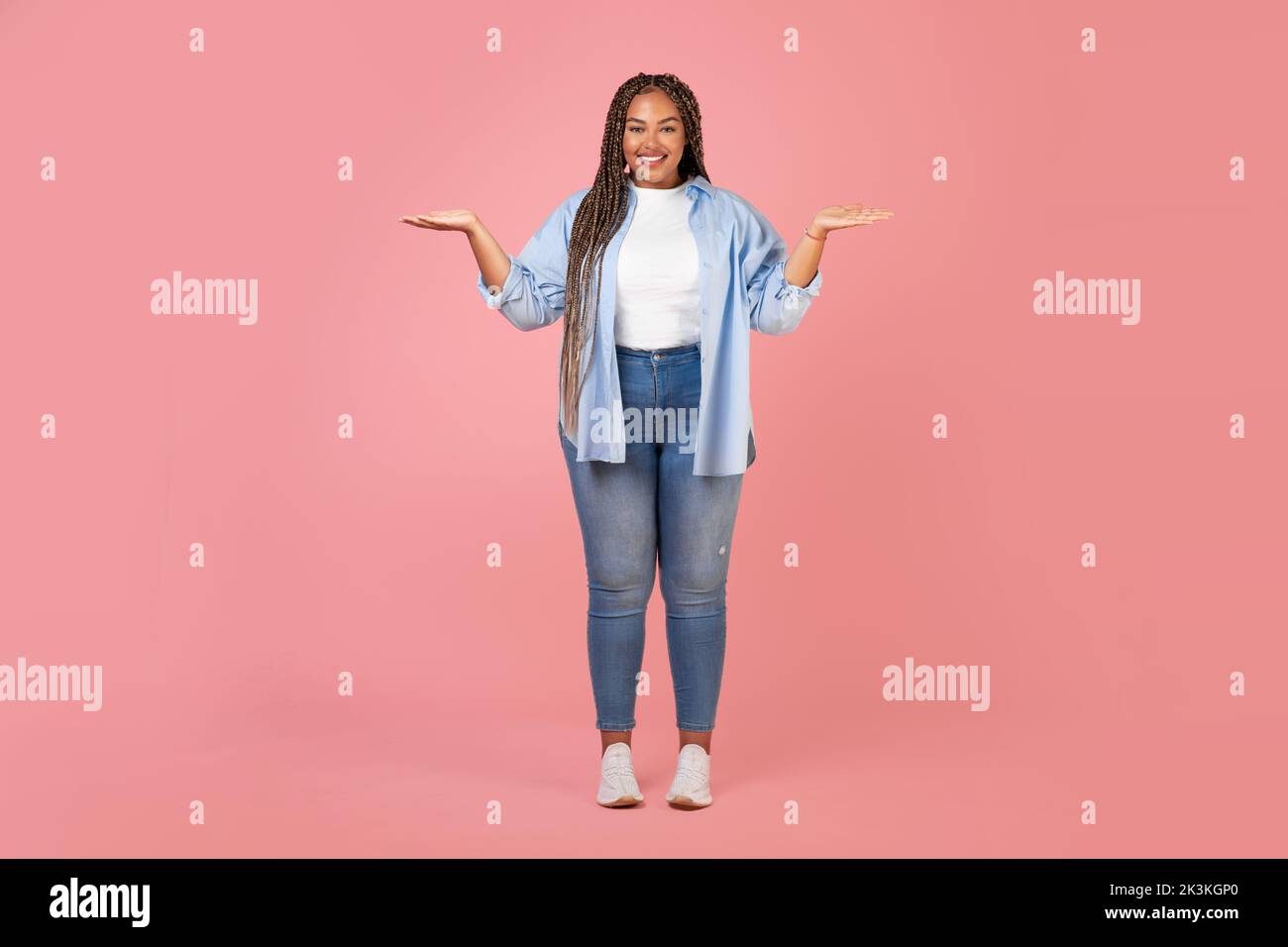 African American Lady Holding Invisible Objects On Hands, Pink ...