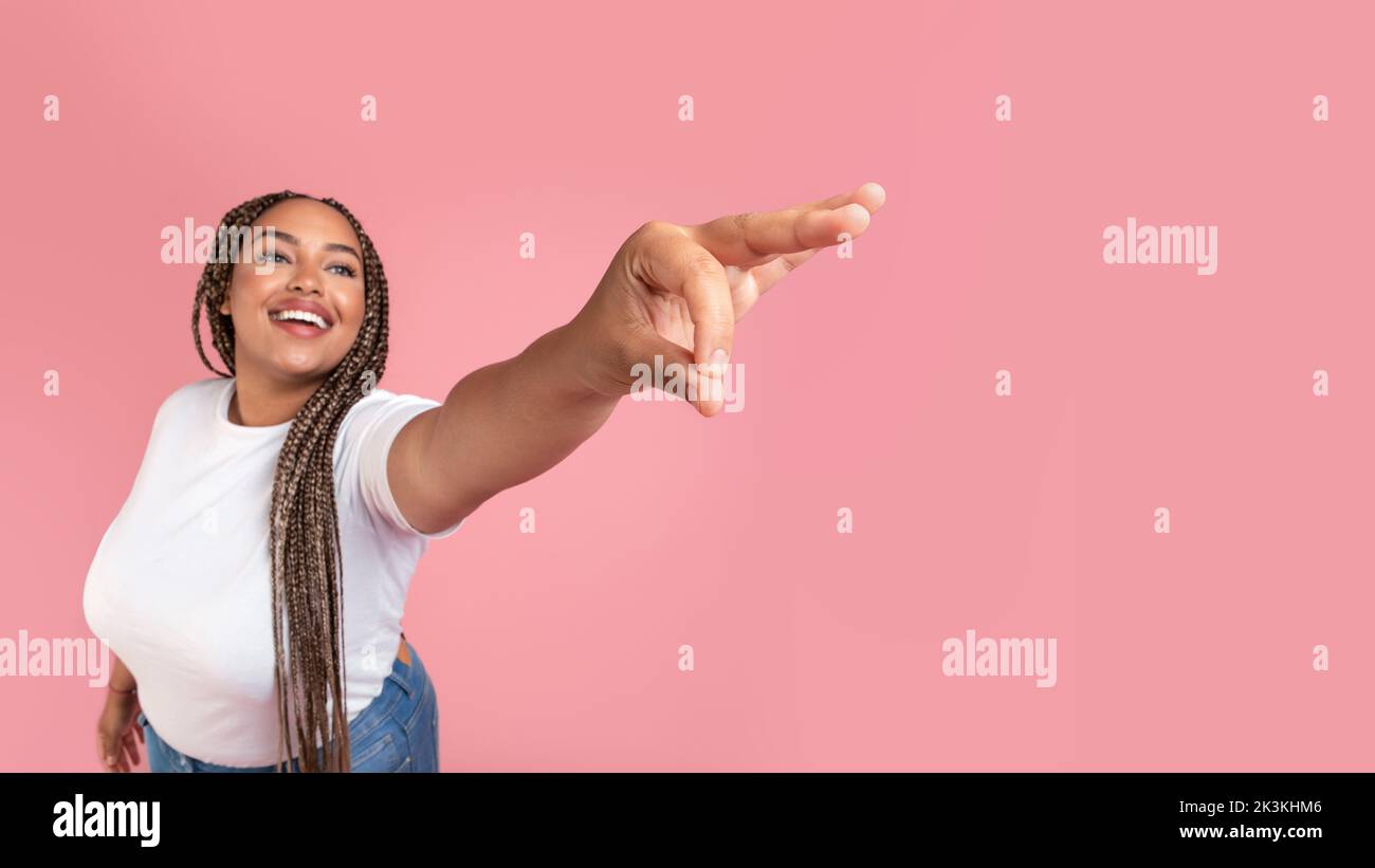 African American Lady Holding Invisible Object In Fingers, Pink ...