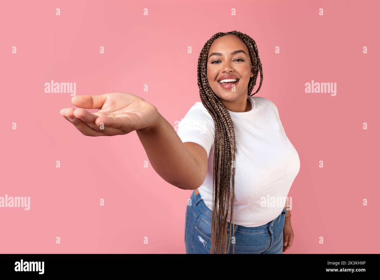 Happy Black Lady Showing Hand Advertising Invisible Product, Pink ...
