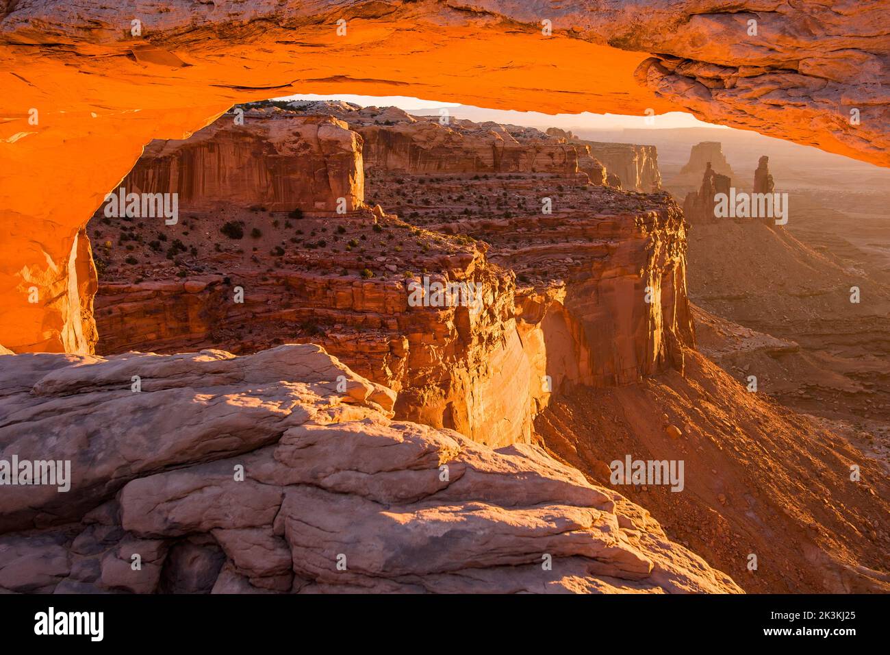 Mesa Arch at sunrise with the Washer Woman Arch, Monster Tower & Airport Tower. Canyonlands ...