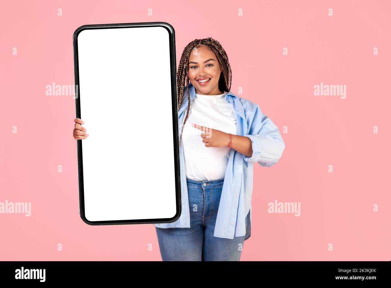 Happy African American Lady Holding Large Cellphone Over Pink ...