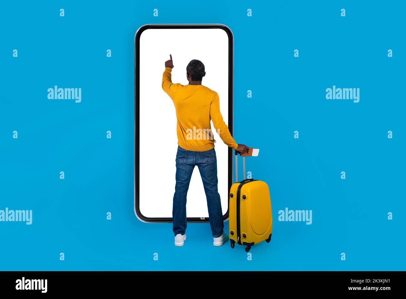 Back view of black man tourist using big cell phone Stock Photo - Alamy