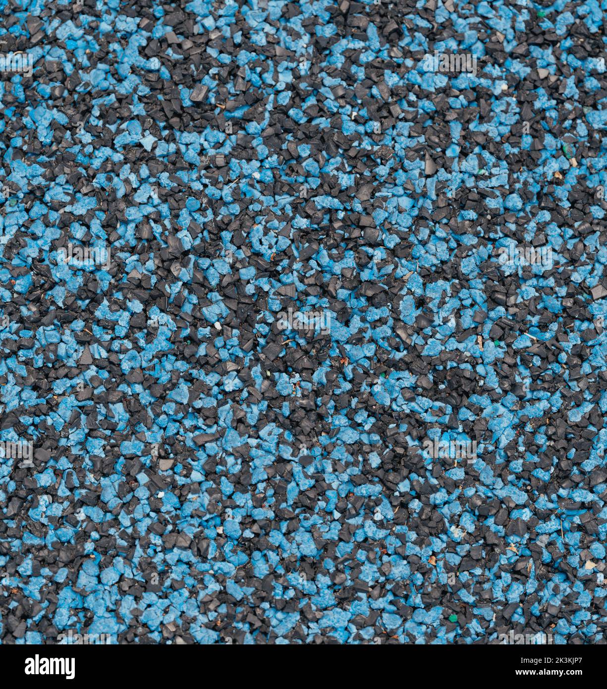 The texture of the street pavement of tracks made of black and blue ...