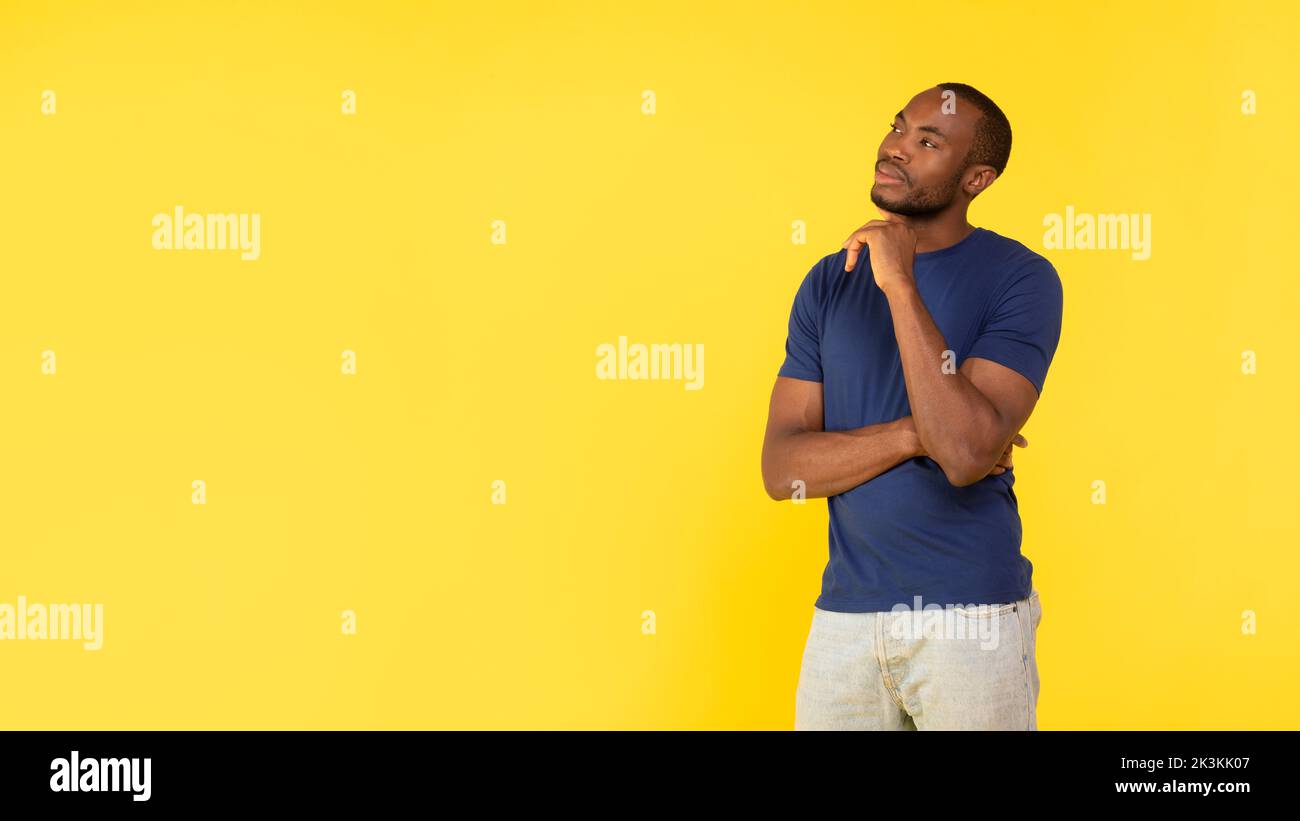 Pensive Black Guy Thinking Touching Chin Posing Over Yellow Background ...