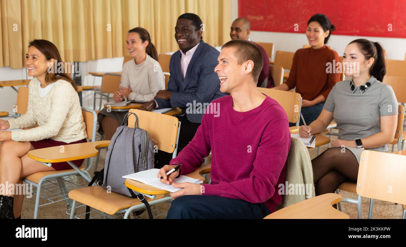 Attentive students at their desks in university auditorium Stock Photo ...