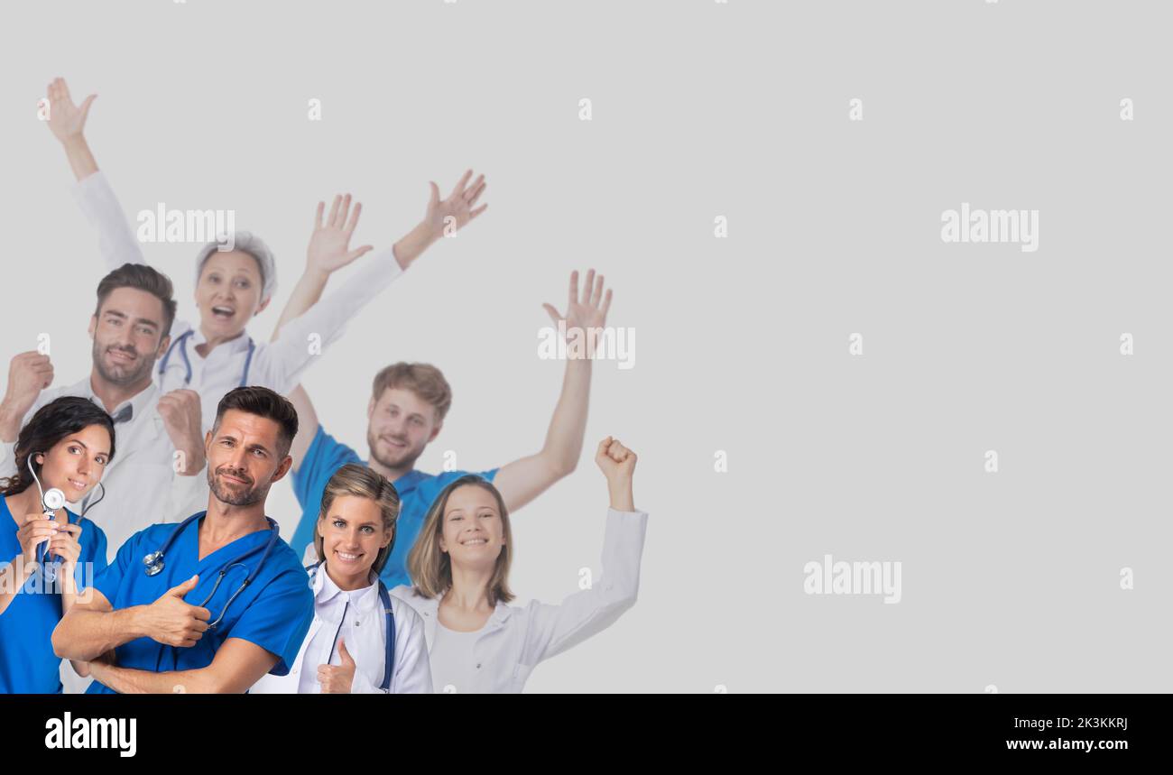 Group of happy smiling doctors raising their arms on gray background ...