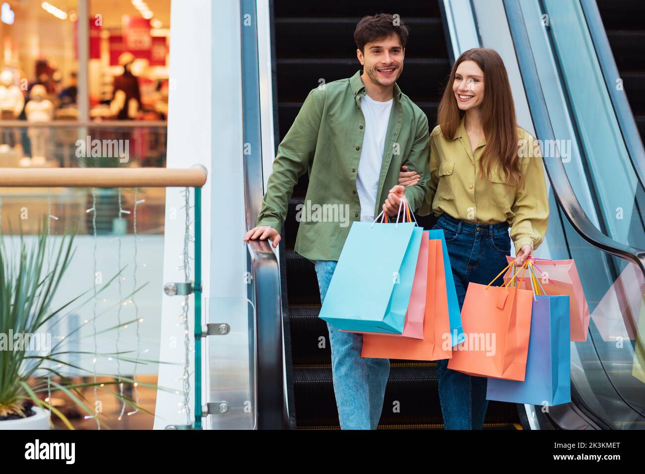 Cheerful Couple Shopping Spending Time In Modern Mall Stock Photo - Alamy