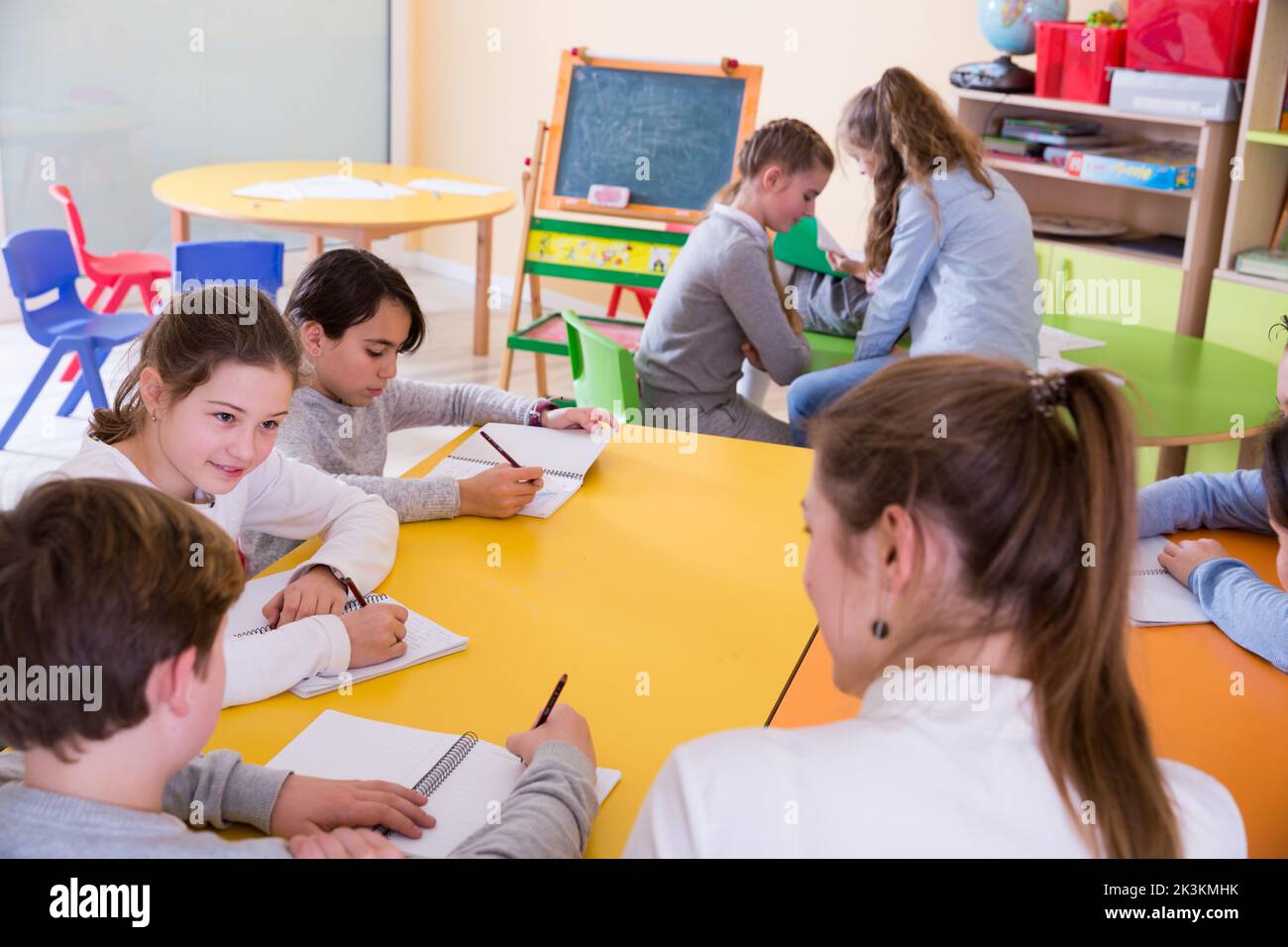 School kids studying in classroom with teacher Stock Photo - Alamy