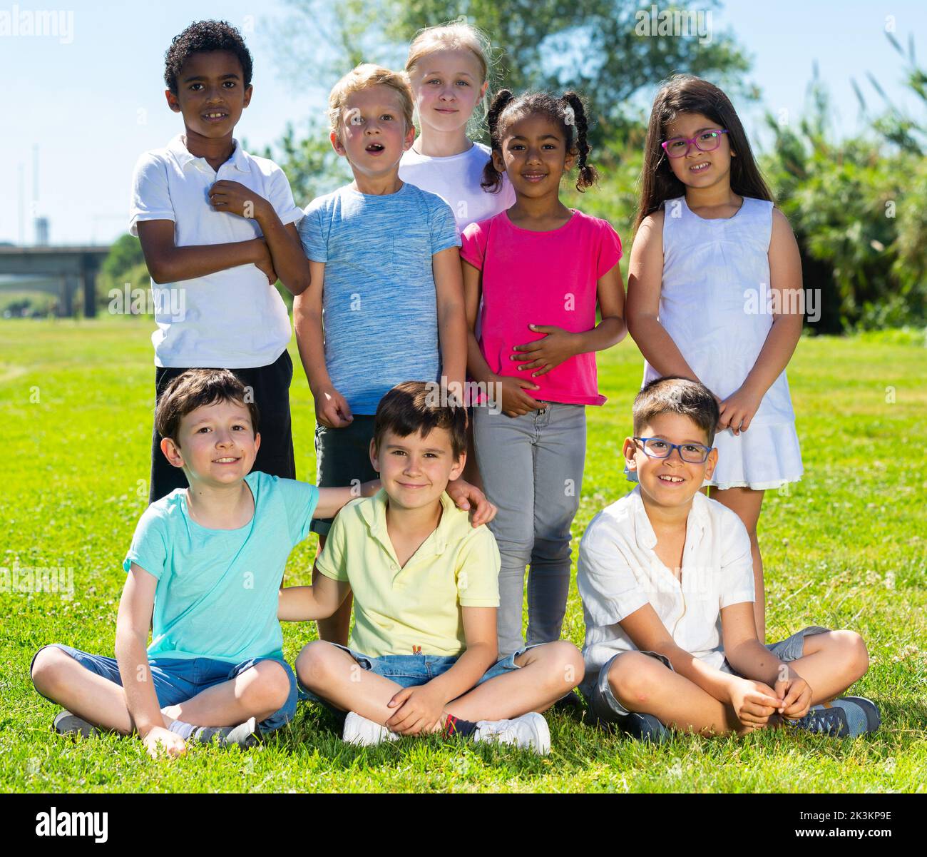 Portrait of eight children who are walking and posing in the park Stock ...