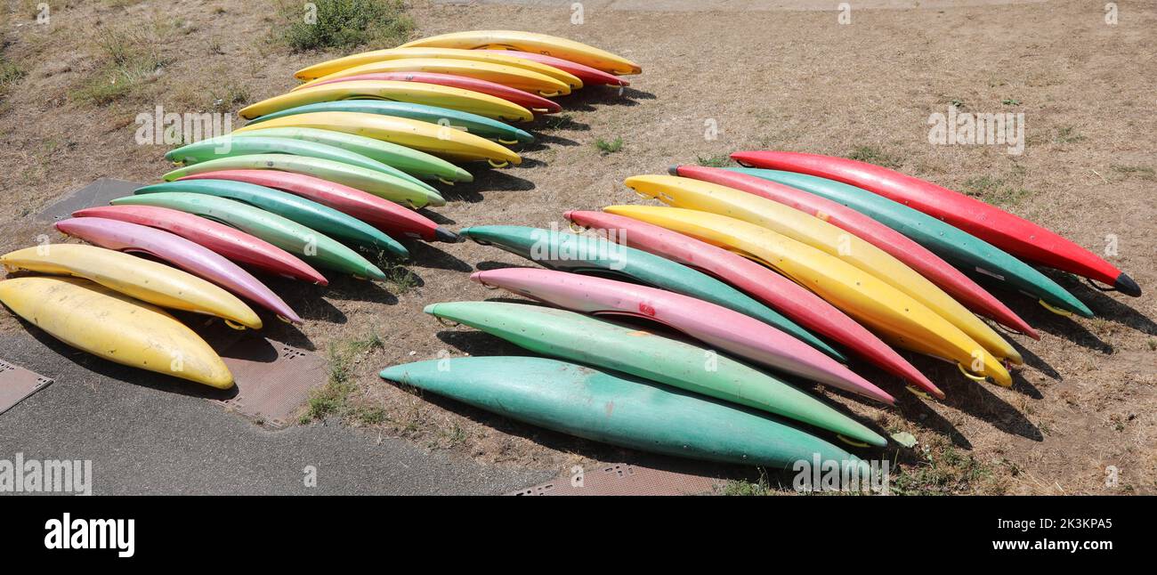 many colorful canoes for the rowing school by the river Stock Photo - Alamy