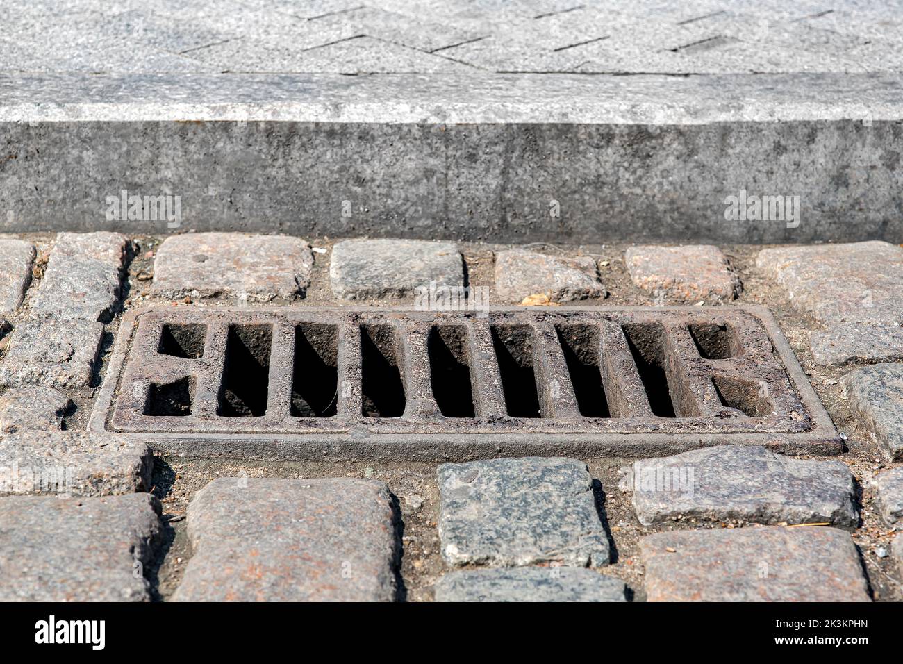 used iron rectangular manhole drainage system on the old cobbled road ...
