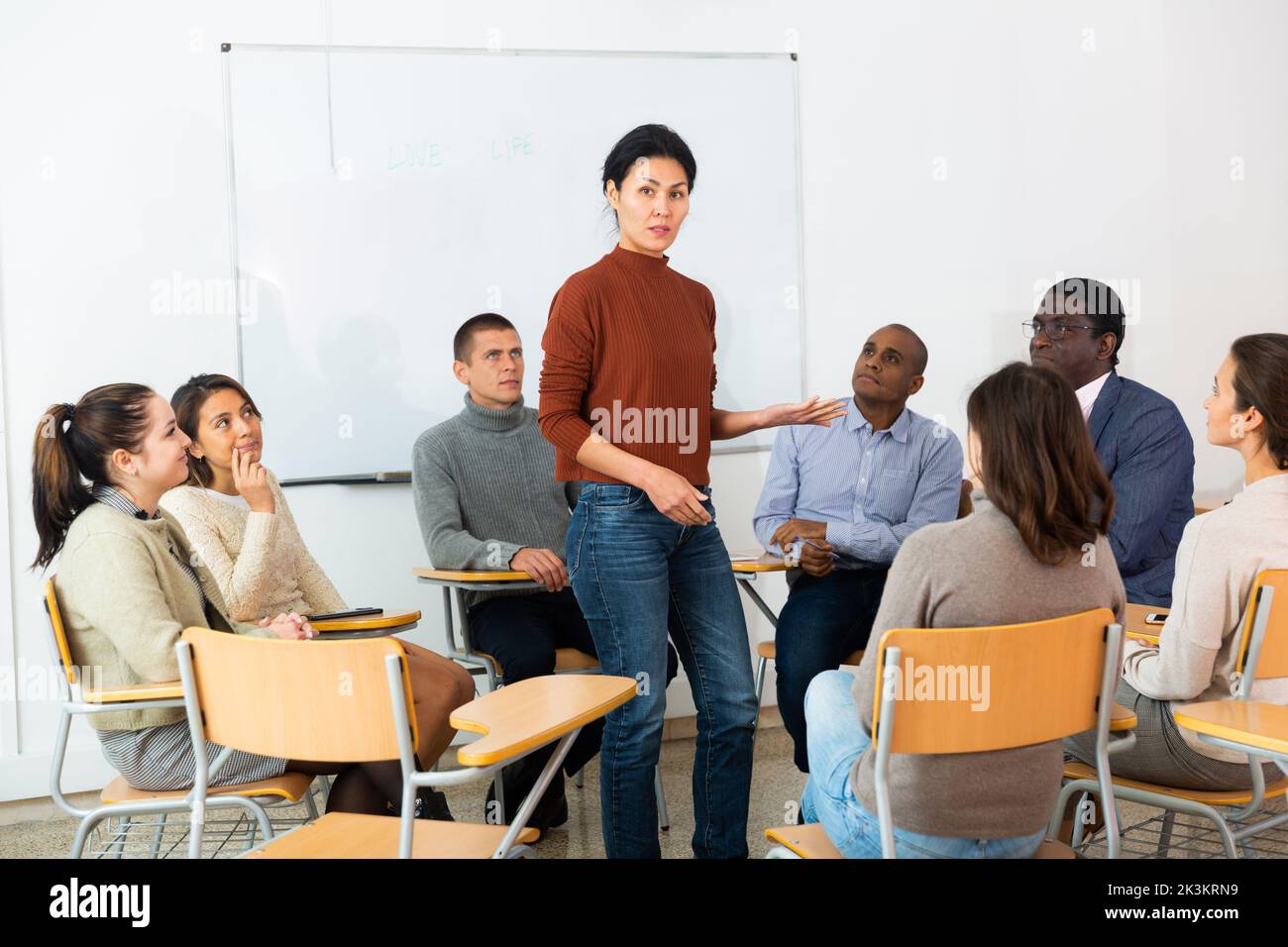 Woman addressing multi-cultural office staff meeting Stock Photo - Alamy