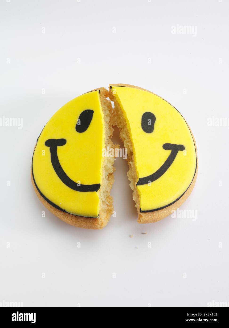Smiley face cookie split in half Stock Photo - Alamy