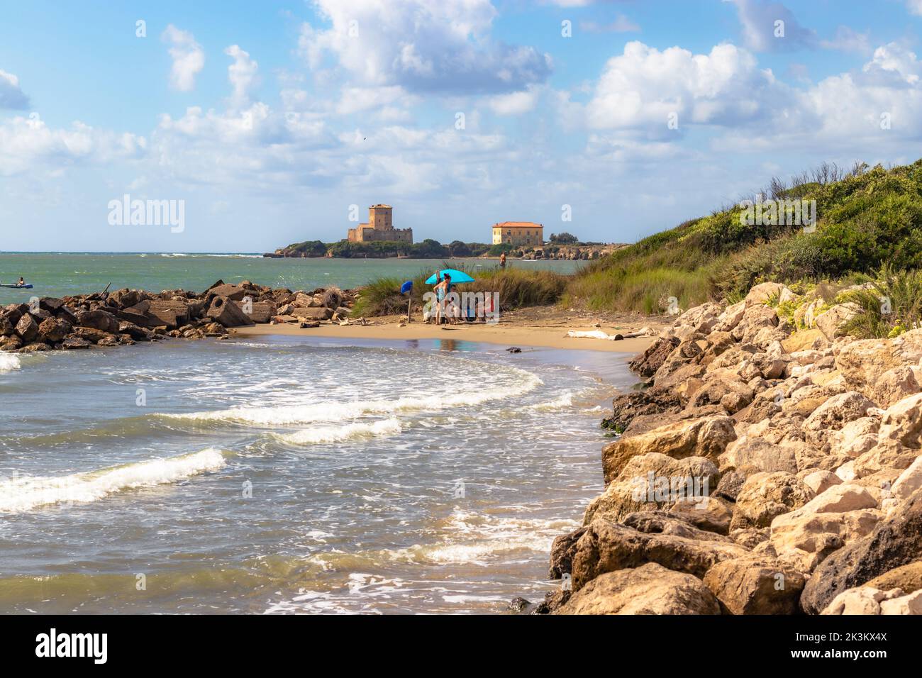 waves splash on the beach in front of the castle Torre Astura, Rome ...