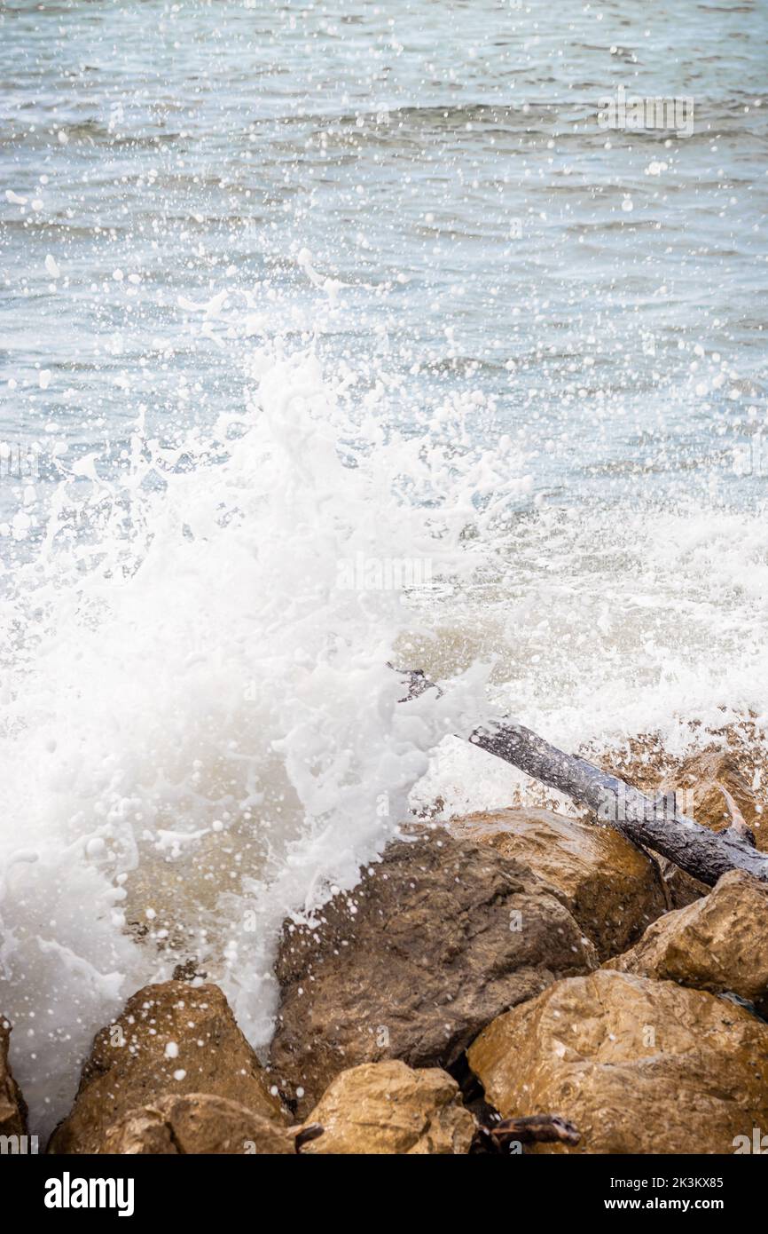 waves splash on the beach in front of the castle Torre Astura, Rome ...