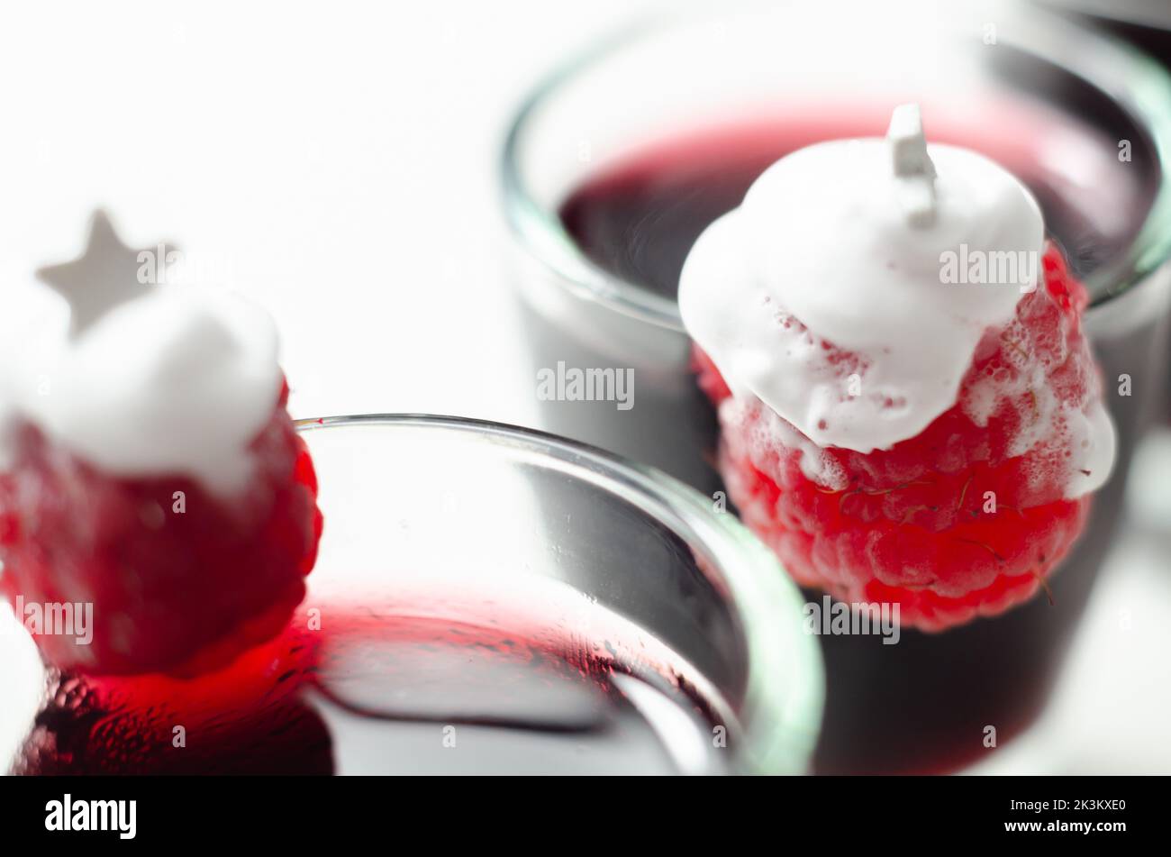 A festive red drink with a Christmas tree decoration made of raspberry ...