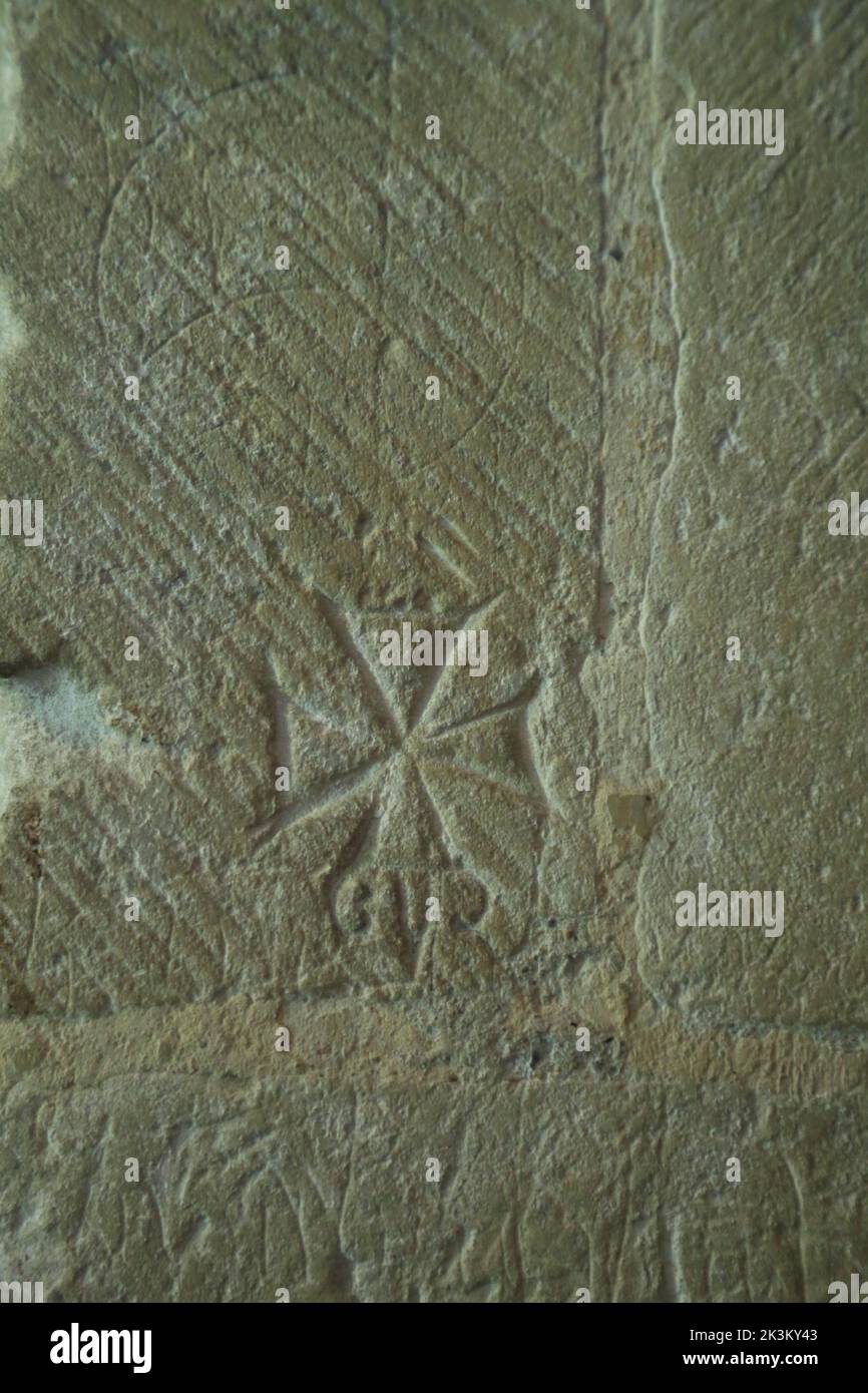 Medieval graffiti and cross carved into doorway of the church of St ...