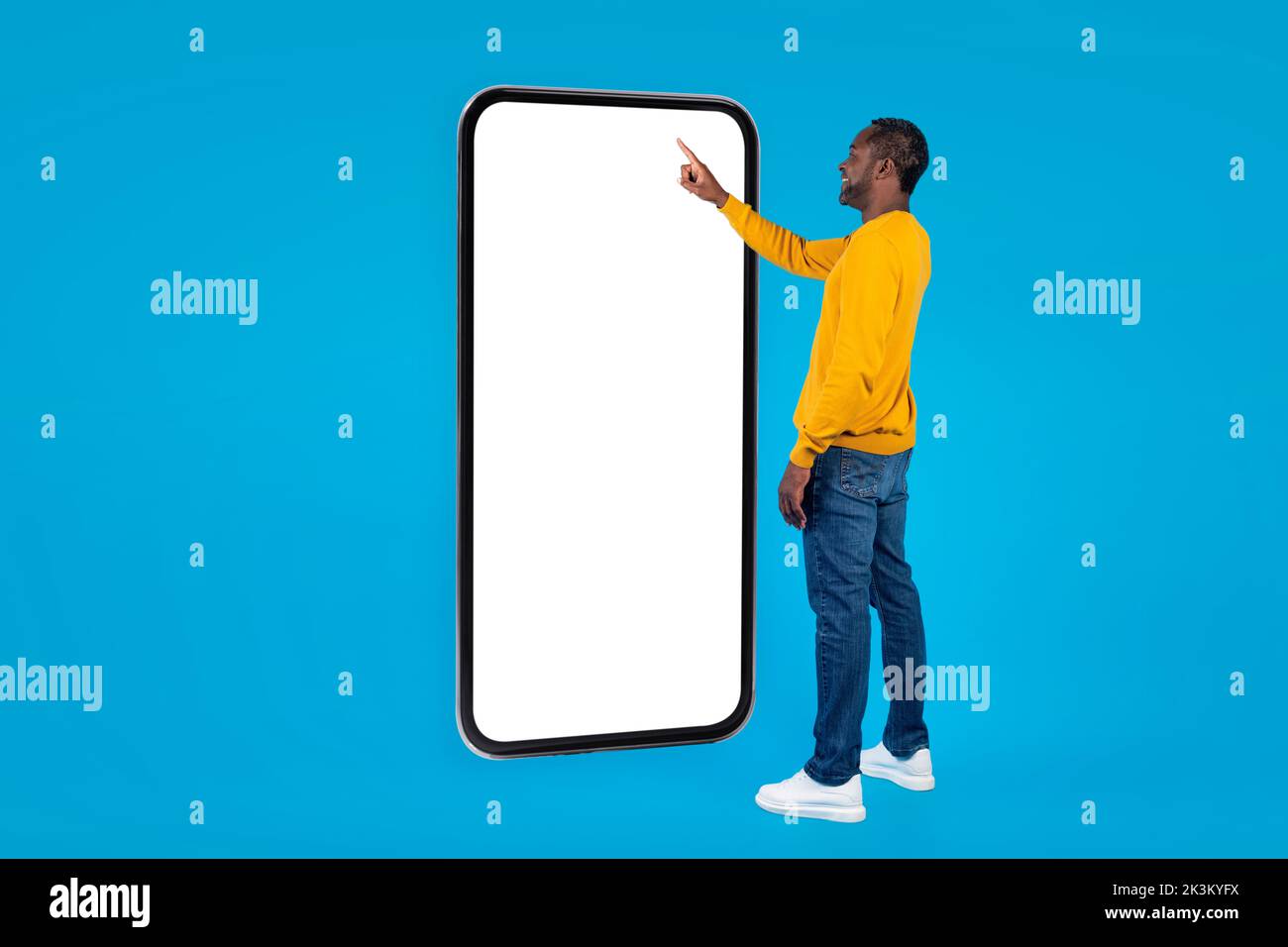 African american man touching big smartphone screen, mockup, full ...
