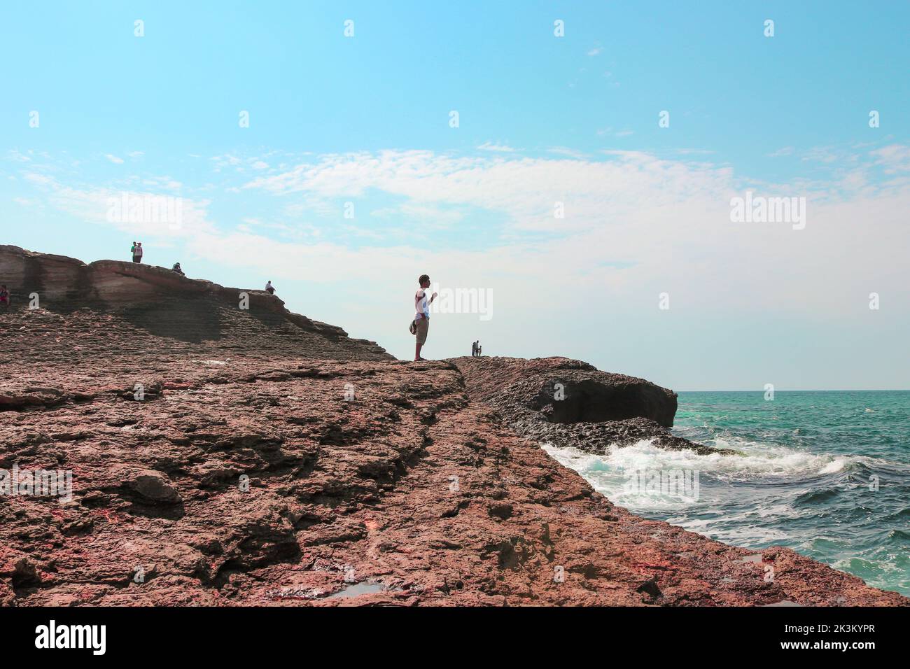 People standing on the rock and looking at the sea. Minimalist ...