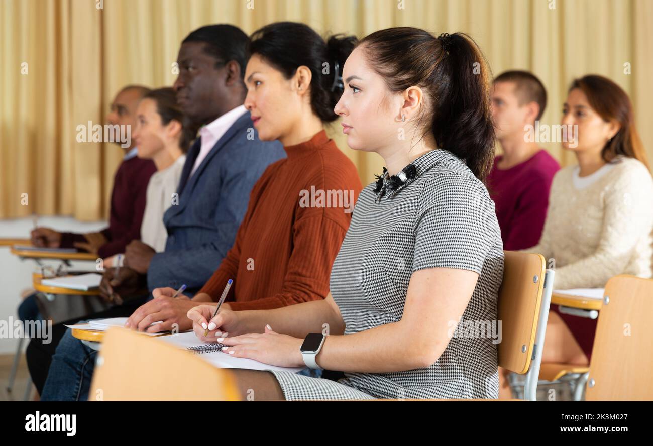 Side view of student group working on lecture in classroom Stock Photo ...