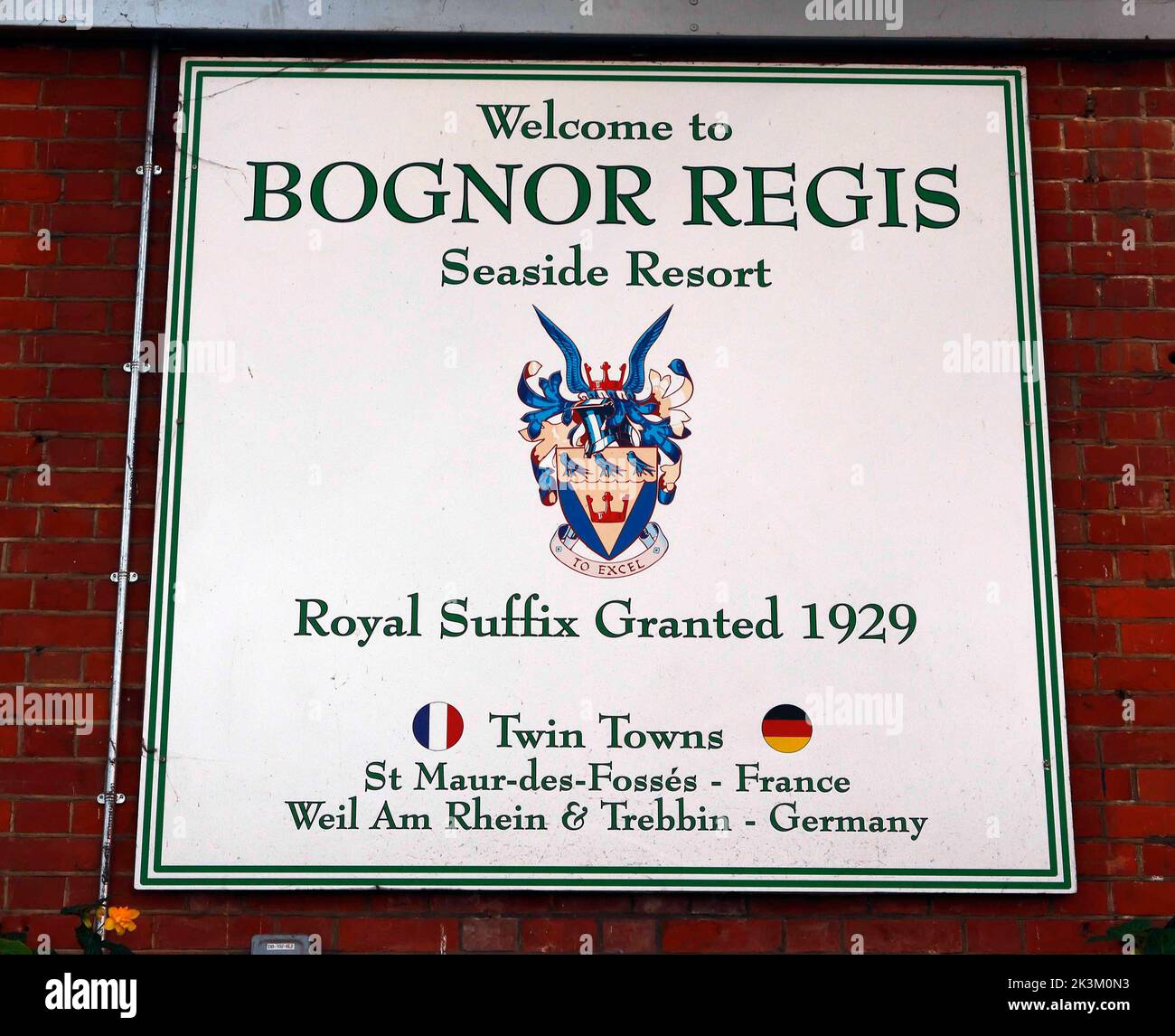Close up of a Welcome to Bognor Regis board seen against a brick wall ...