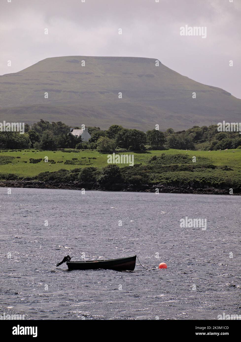 Macleod's Table North and a fishing boat on Loch Dunvegan from near the ...