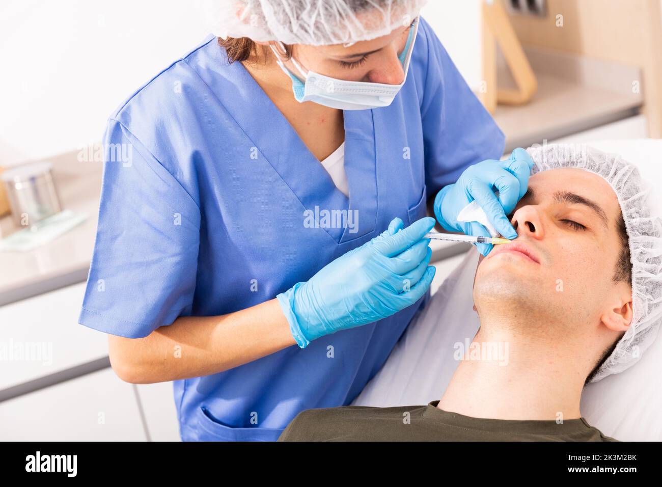 Man getting face injections at aesthetic clinic Stock Photo - Alamy