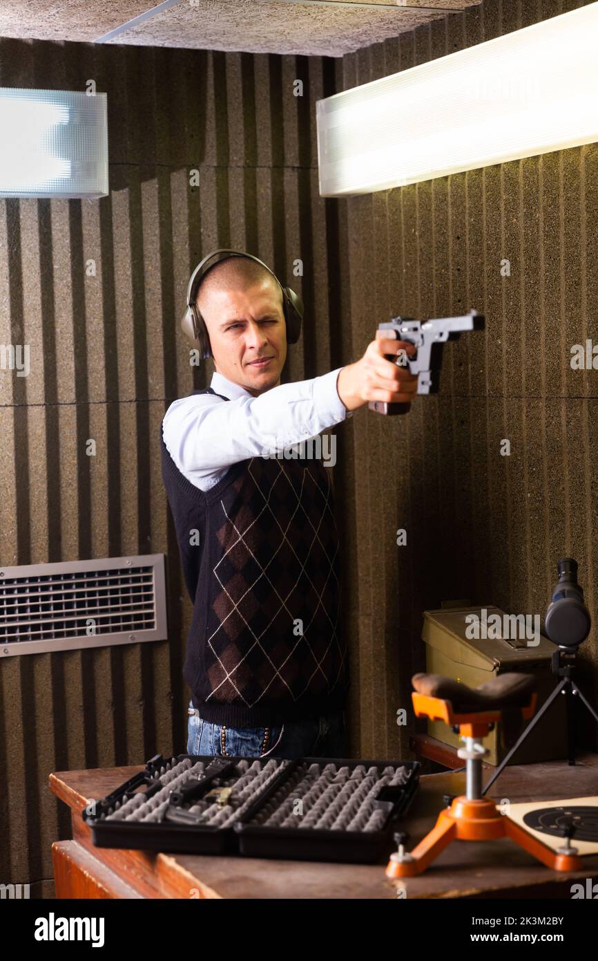 Shooting a combat pistol in shooting range Stock Photo - Alamy