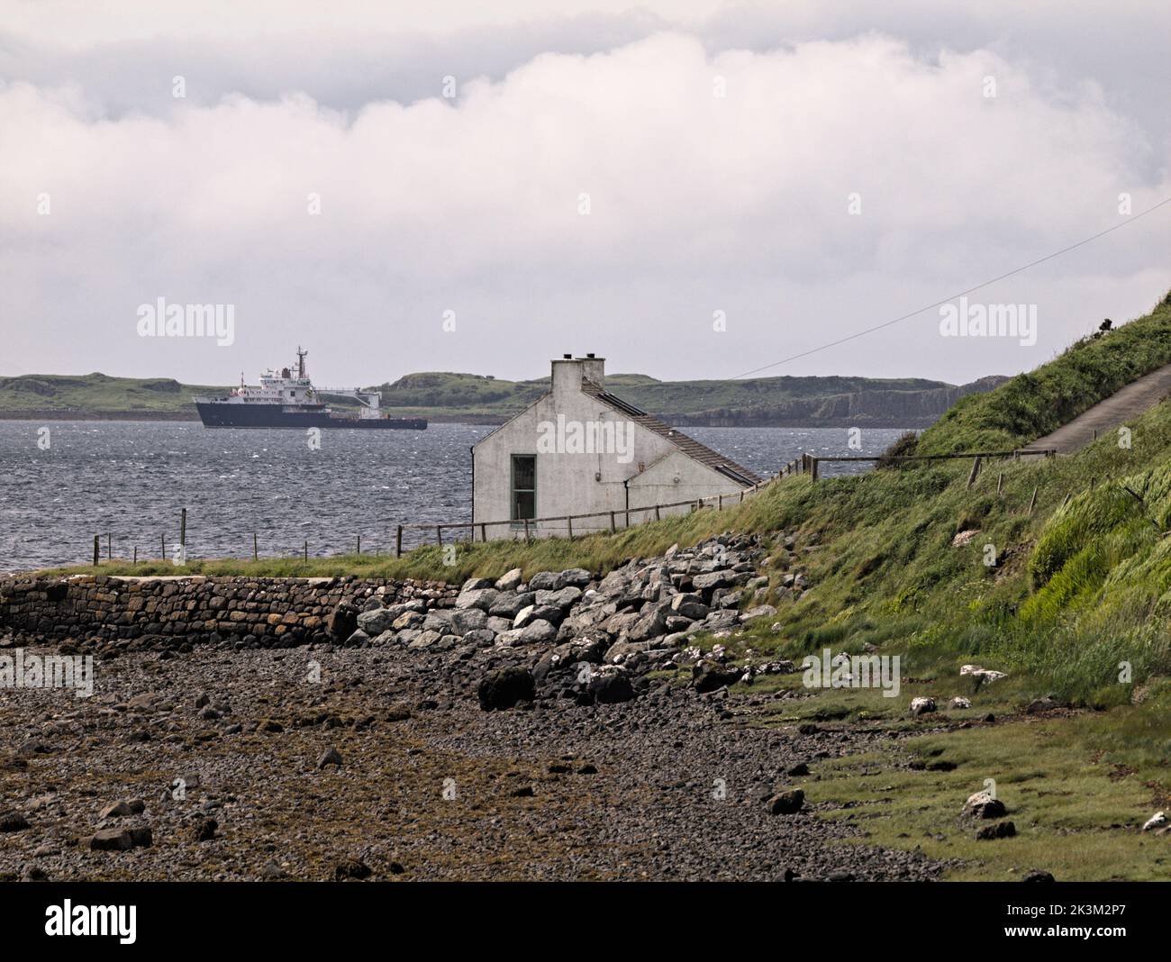 A fishing boat in Loch Bay with the north pier at Stein, Waternish ...
