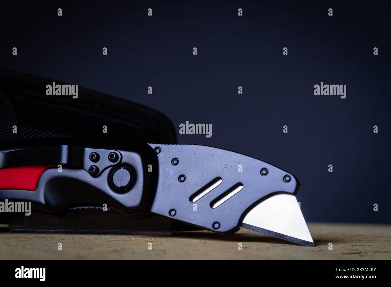 Universal powerful knife. Folding tool that cuts paper, plastic ...