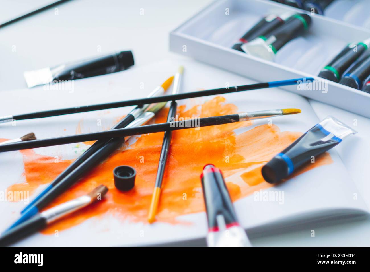 Artist's workplace. Paint and brushes on canvas. Artist workflow ...