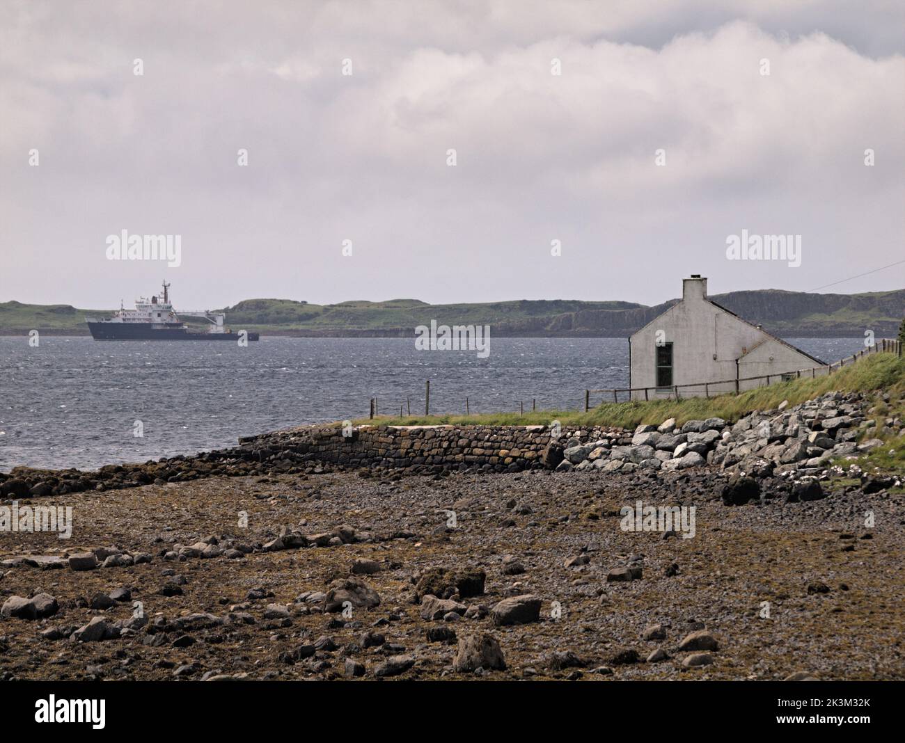 A fishing boat in Loch Bay with the north pier at Stein, Waternish ...
