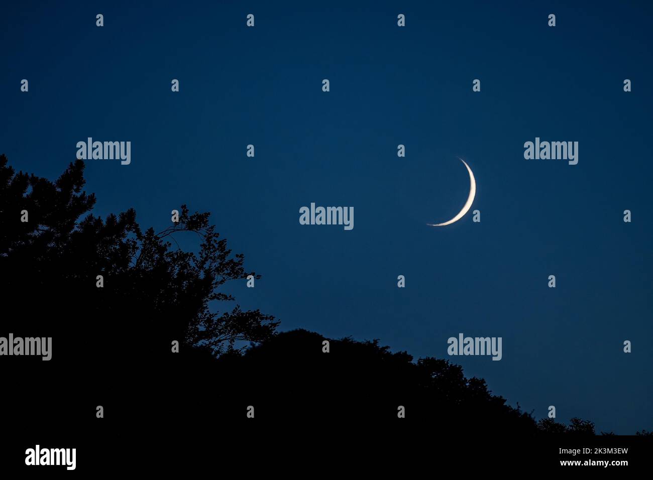 Crescent moon over hillside, Wales, UK Stock Photo - Alamy