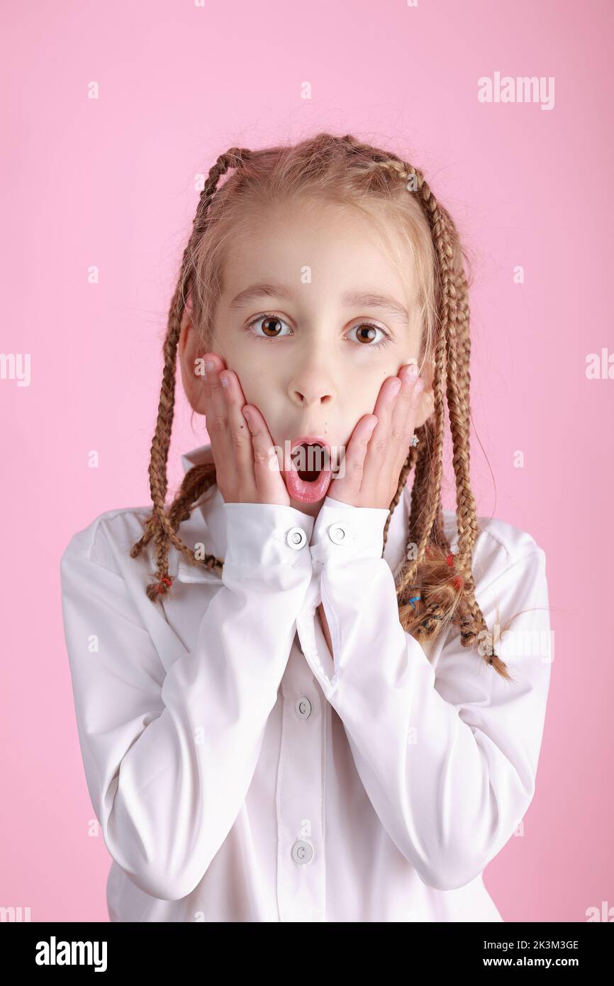 Surprised, wow, shock. Portrait of cute girl with funny hairdo pigtails ...